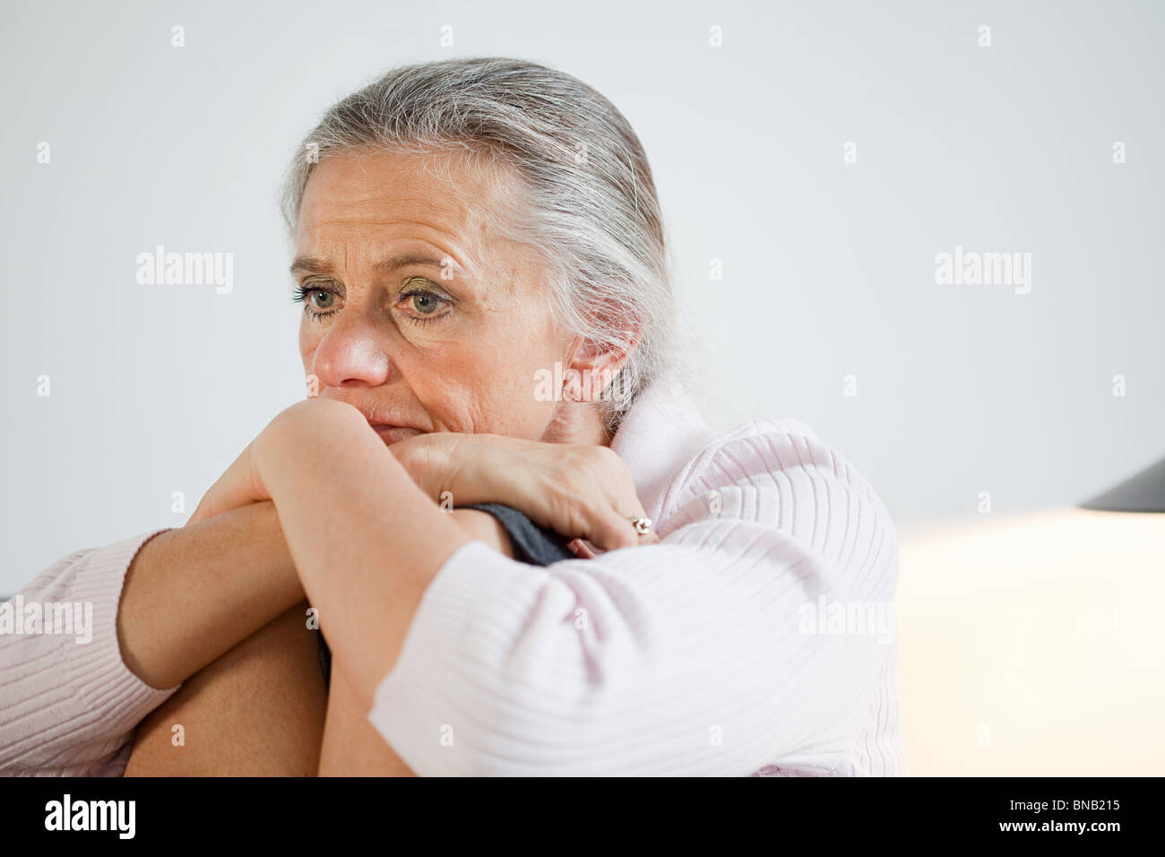 Mature woman looking anxious Stock Photo - Alamy