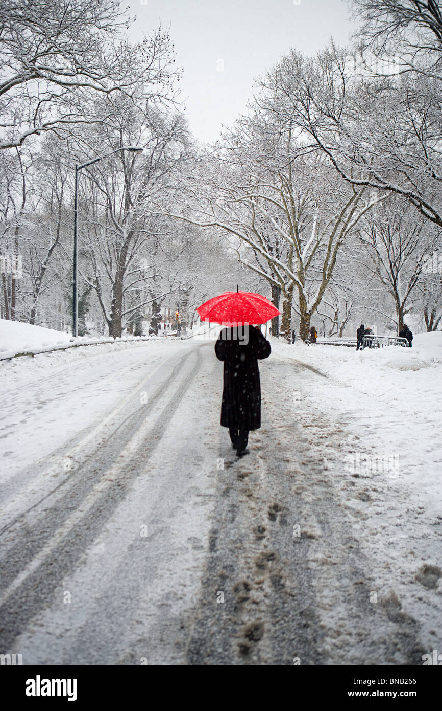 Person with red umbrella walking in snow Stock Photo - Alamy