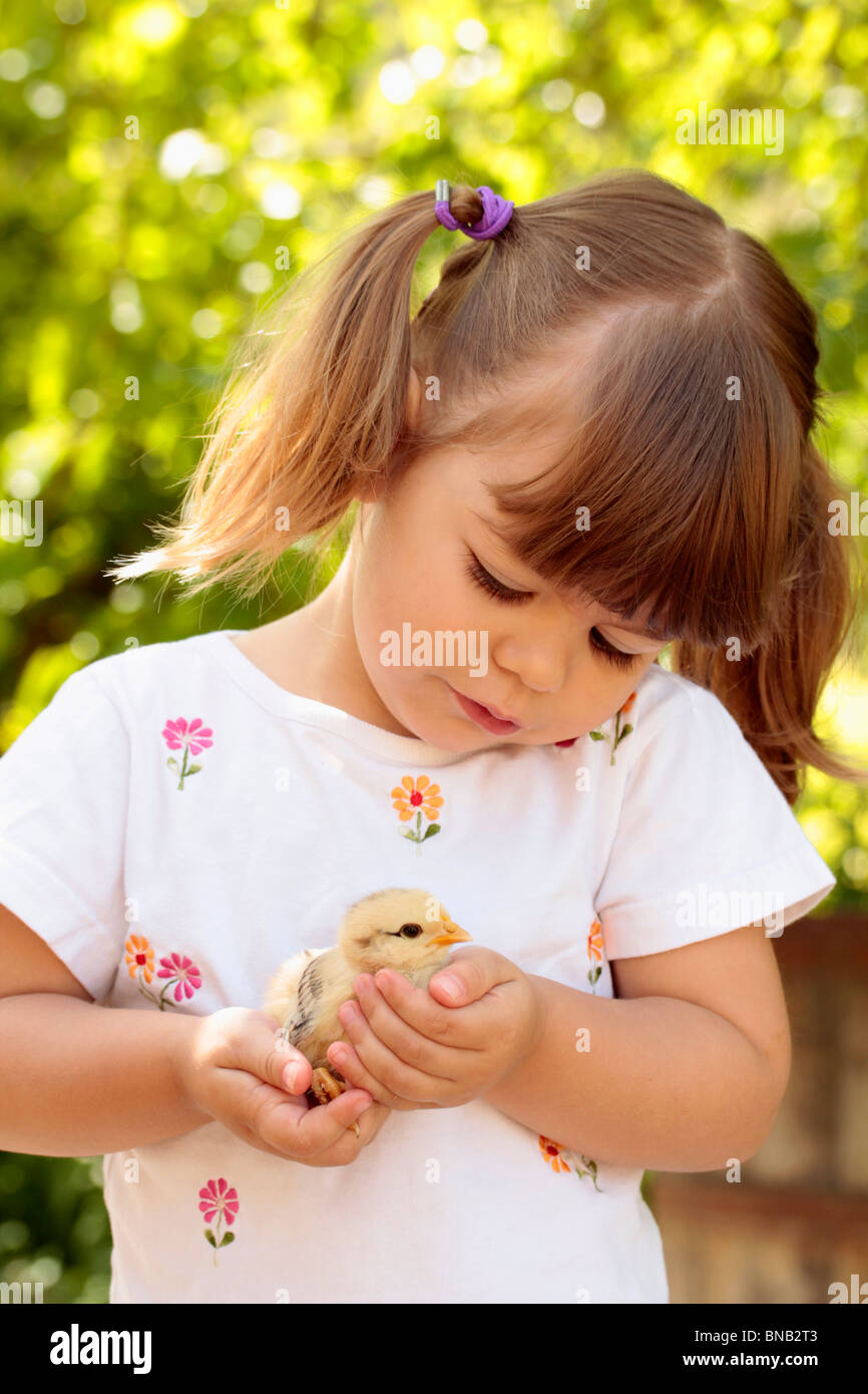 Little girl and chick Stock Photo - Alamy