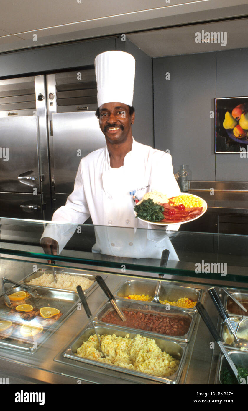 Black african american male chef handing out food in an office ...