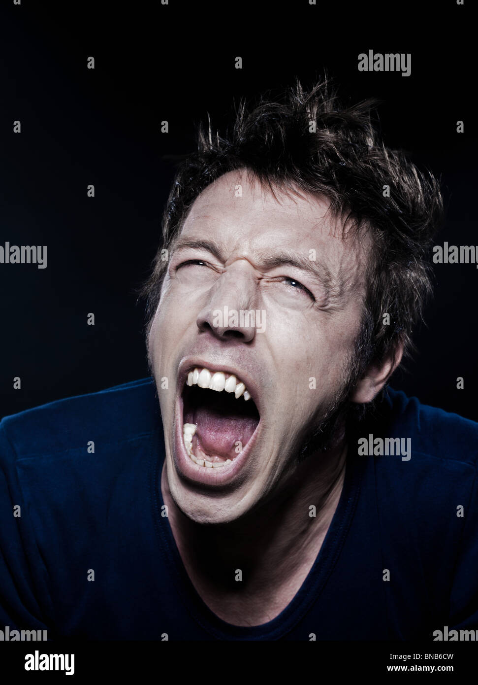 studio portrait on black background of a funny expressive caucasian man ...