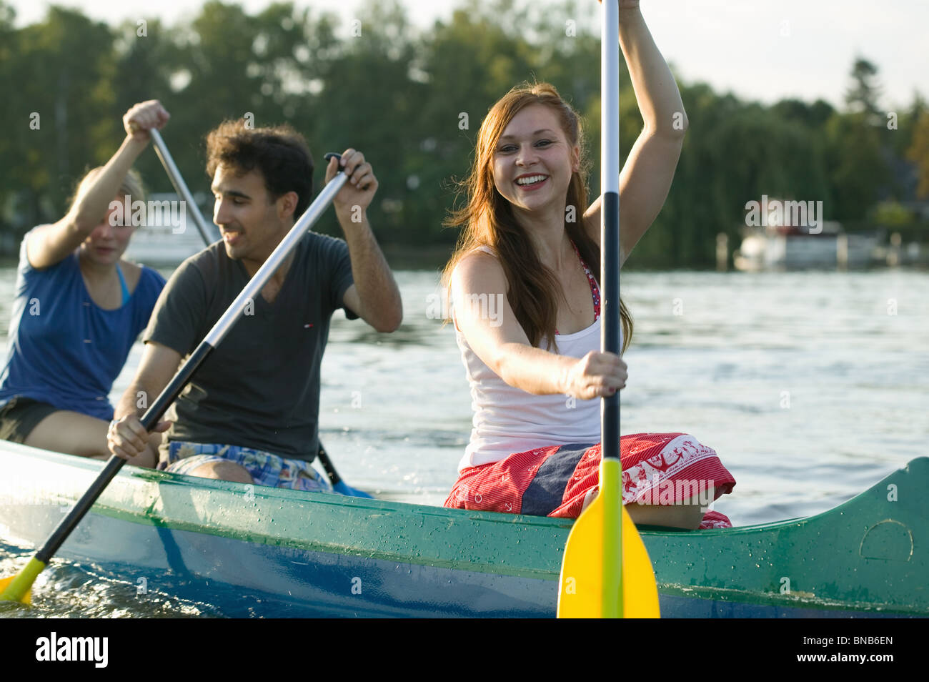 Three people rowing canoe hi-res stock photography and images - Alamy