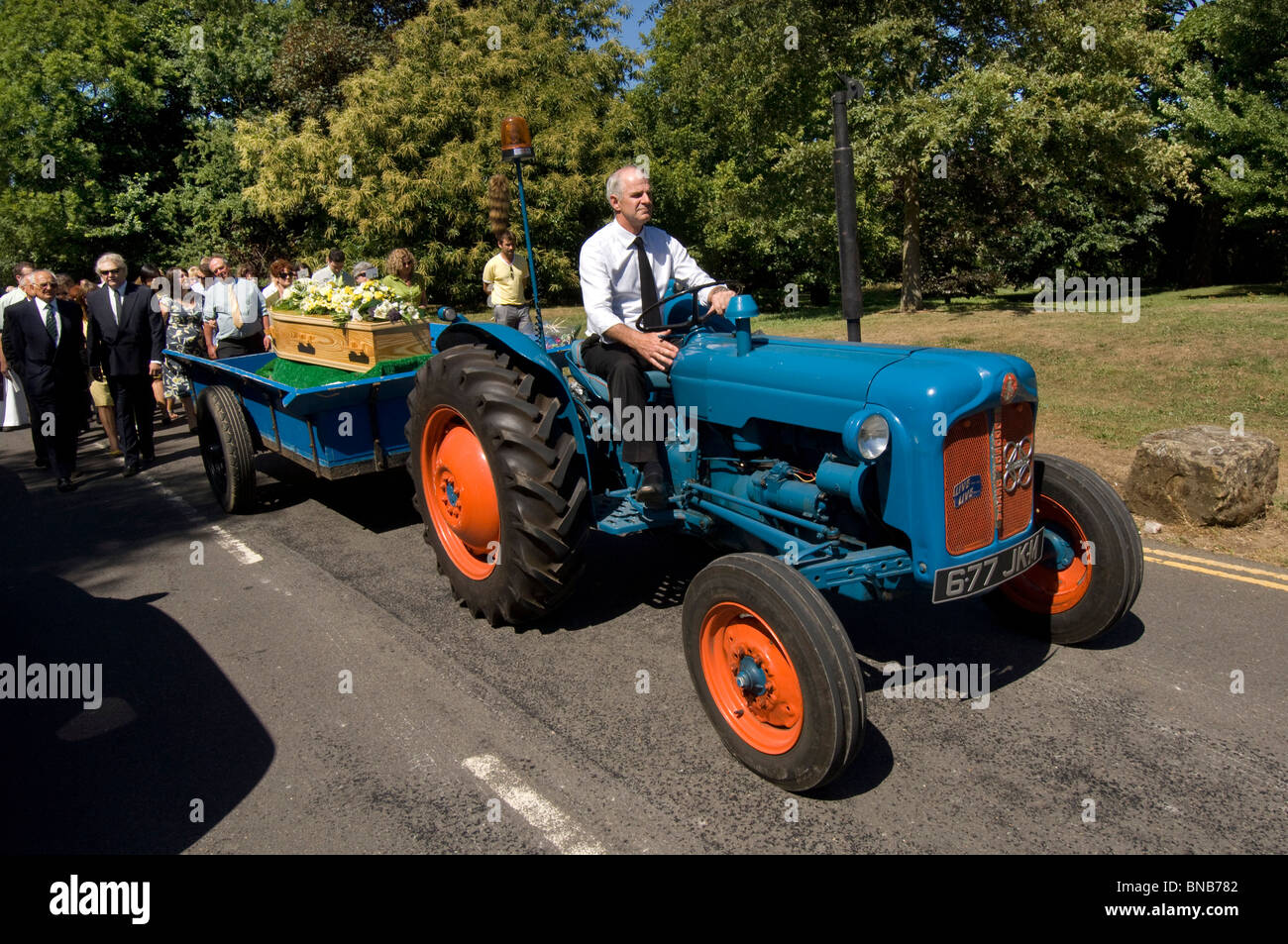 A vintage 1960 Fordson Dexta tractor pulls the coffin in a village ...