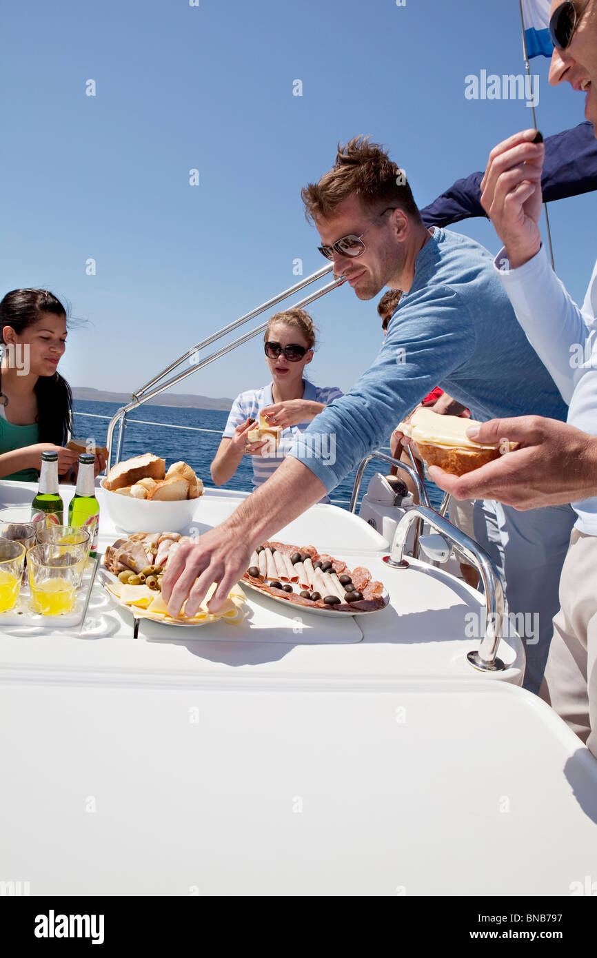 Team eating lunch on yacht Stock Photo - Alamy