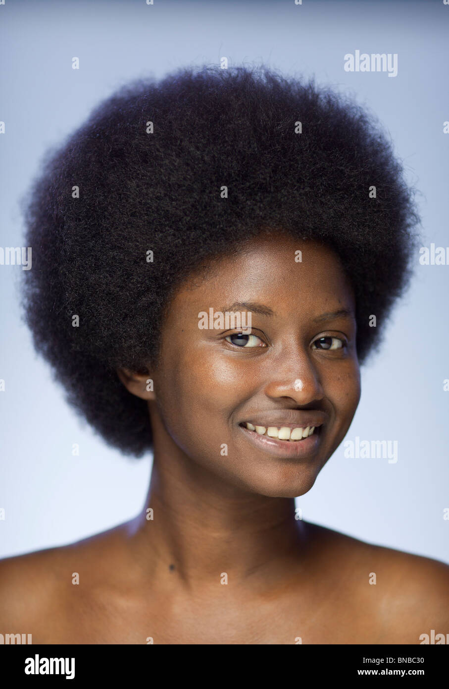 Close-up portrait of confident young black woman with retro style afro ...