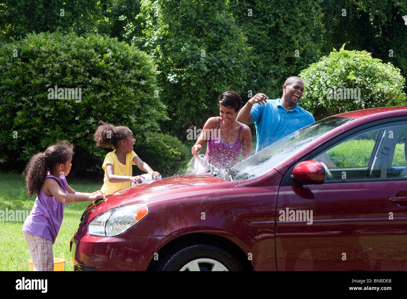 Family washing car and having fun Stock Photo - Alamy