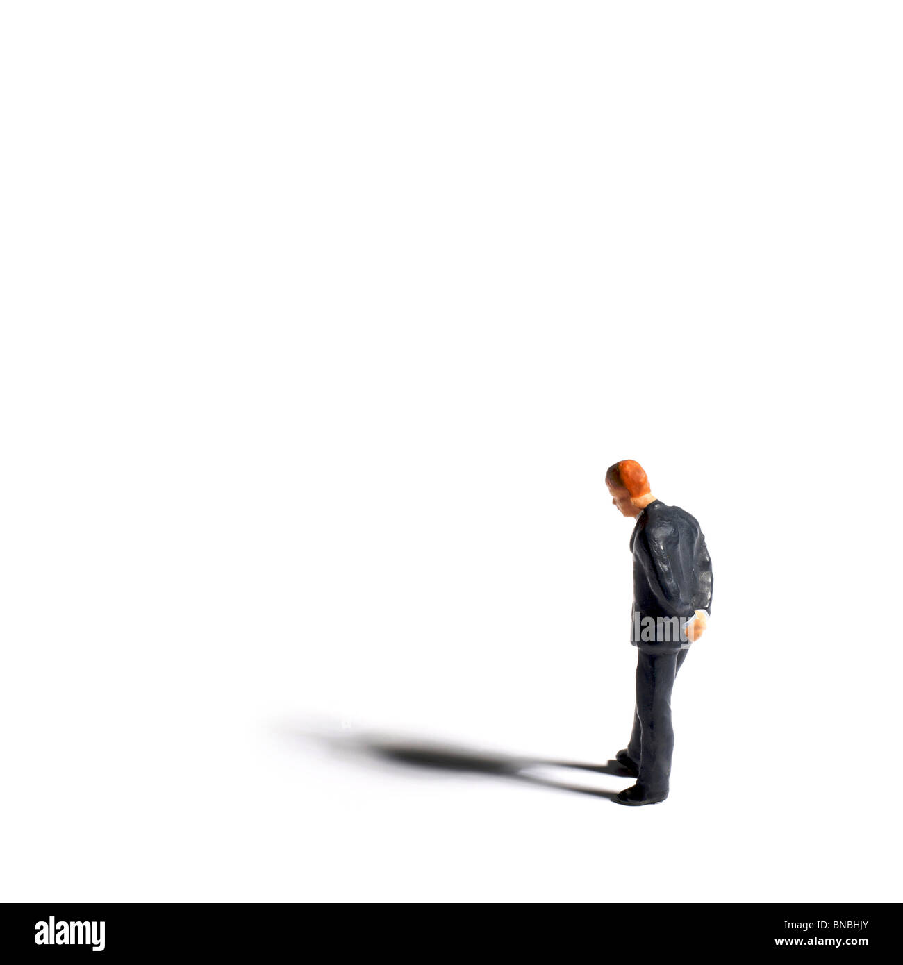 Figure stands alone, casting a long shadow, contemplating in a vast ...