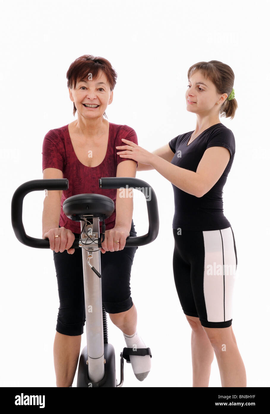 Spinning senior woman with coach Stock Photo - Alamy