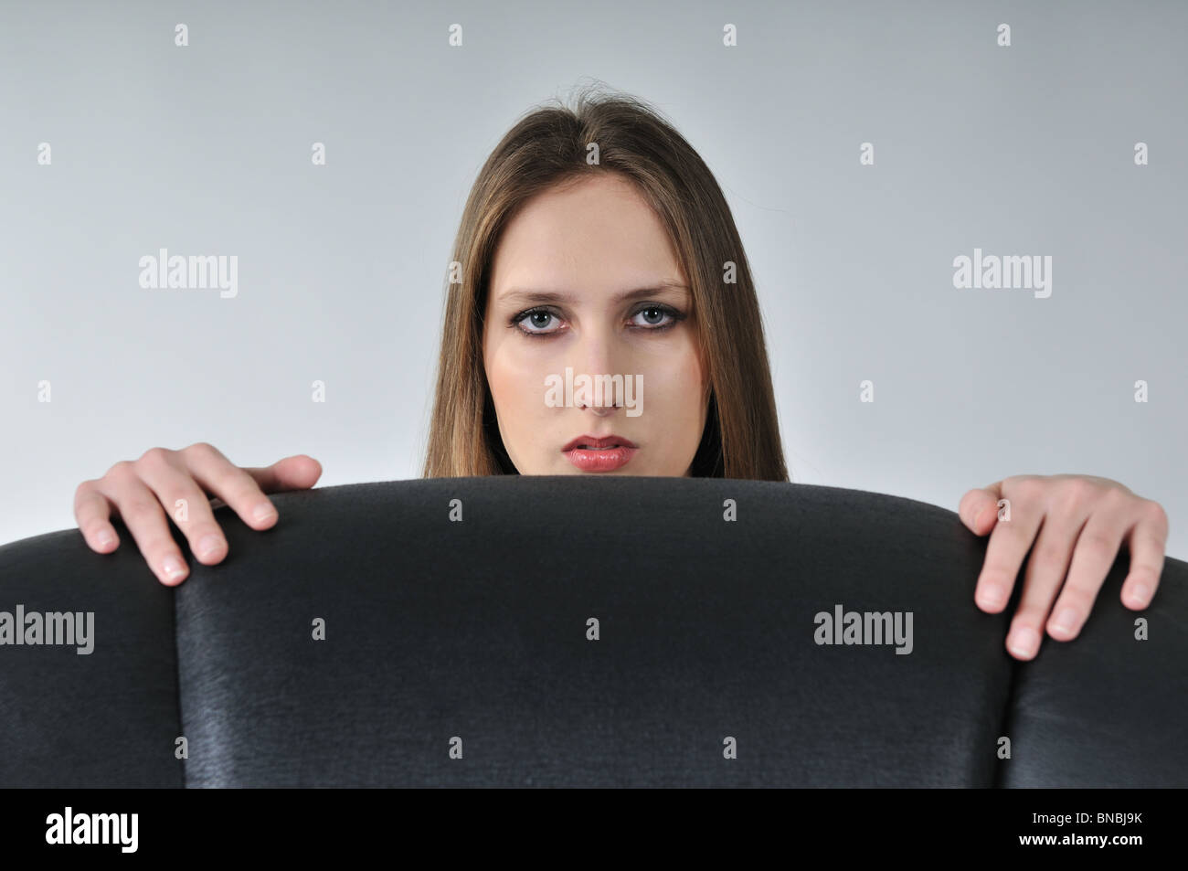 Girl hiding behind chair hi-res stock photography and images - Alamy