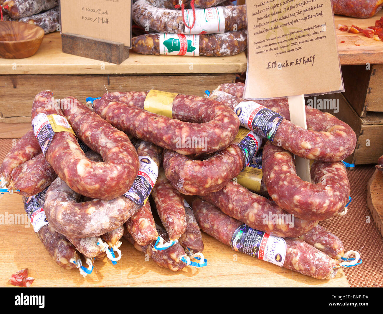 Smoked salami on display for sale at a market delicatessen stall Stock ...