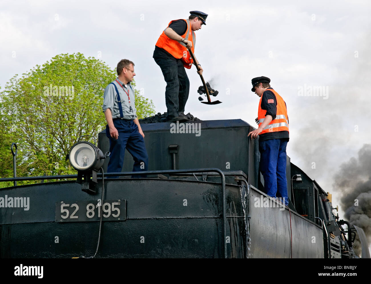 Loading coal onto steam locomotive at railway museum Germany Stock ...