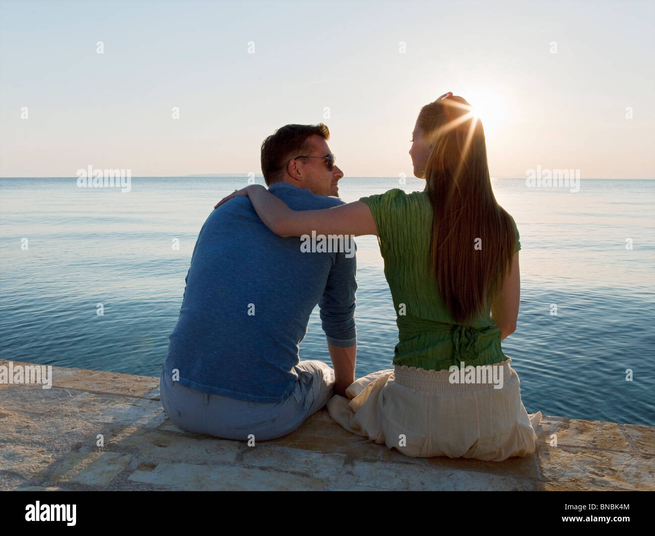 Woman watching sun set hi-res stock photography and images - Alamy