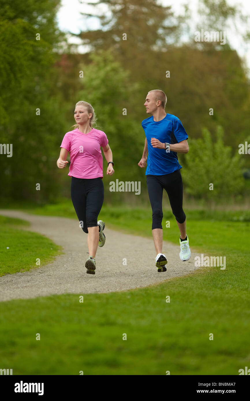Man and woman running in nature Stock Photo - Alamy