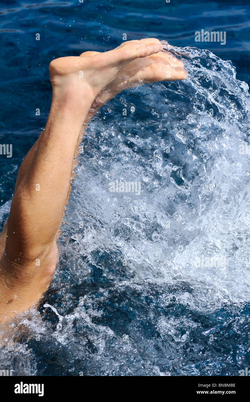 Young man jumping into water Stock Photo - Alamy