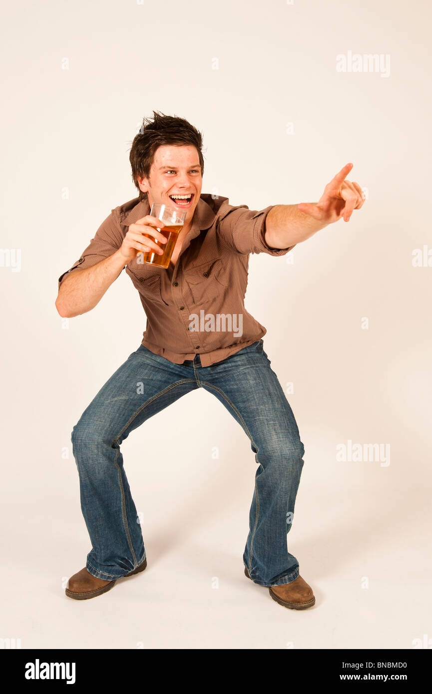 Happy young man drinking a pint of beer lager Stock Photo - Alamy