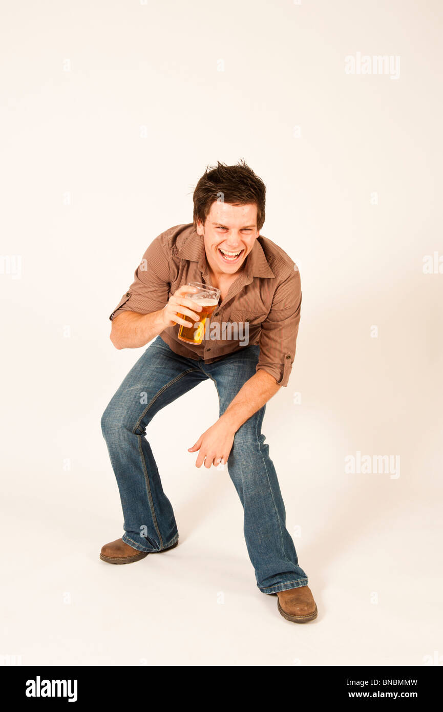 Happy young man drinking a pint of beer lager Stock Photo - Alamy