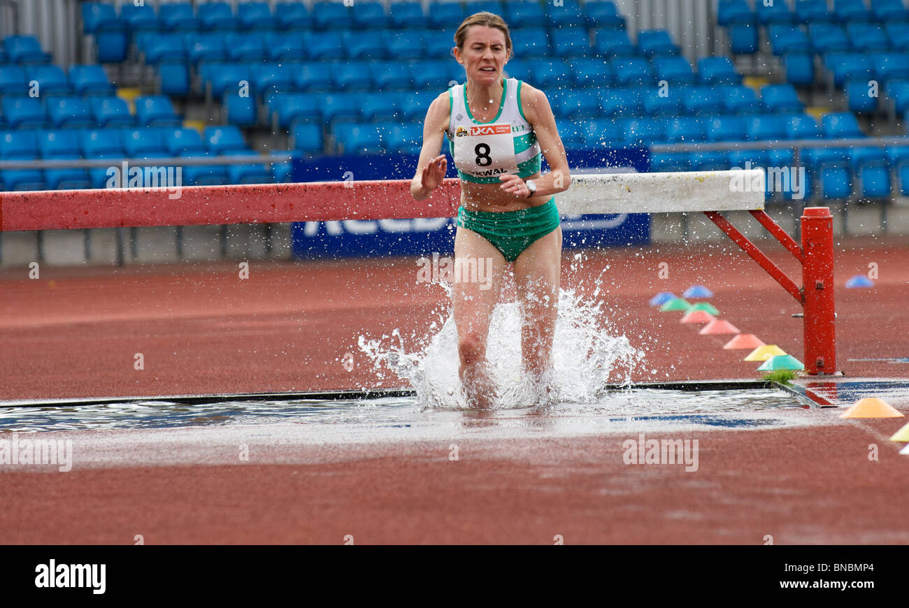 female athlete at the water-jump in the 3.000m steeplechase at ...