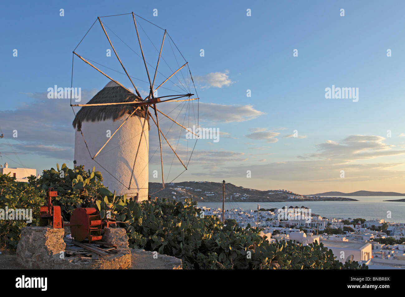 a traditional windmill overlooking the harbour of Mykonos town, Mykonos ...