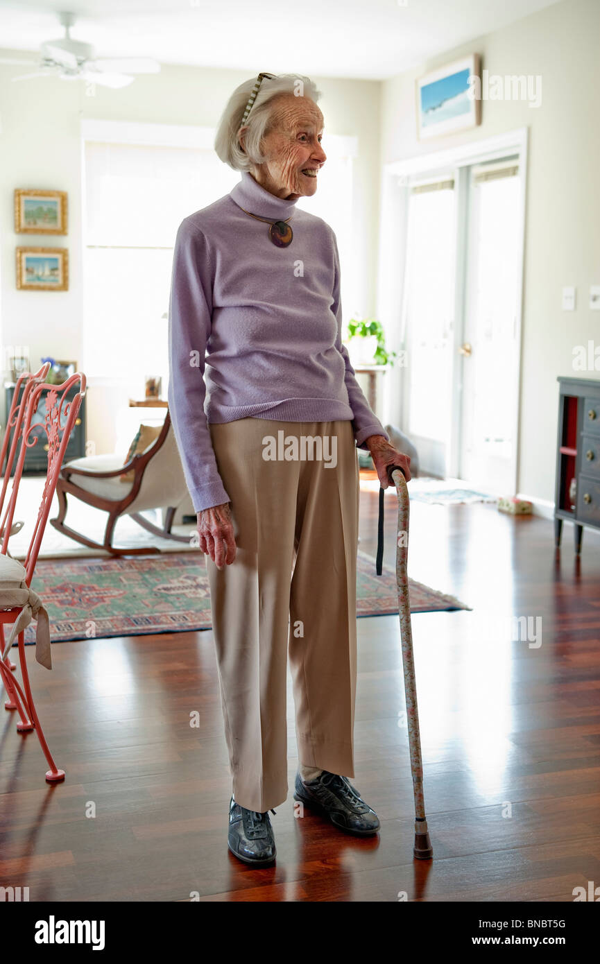Senior woman standing in her living room Stock Photo - Alamy