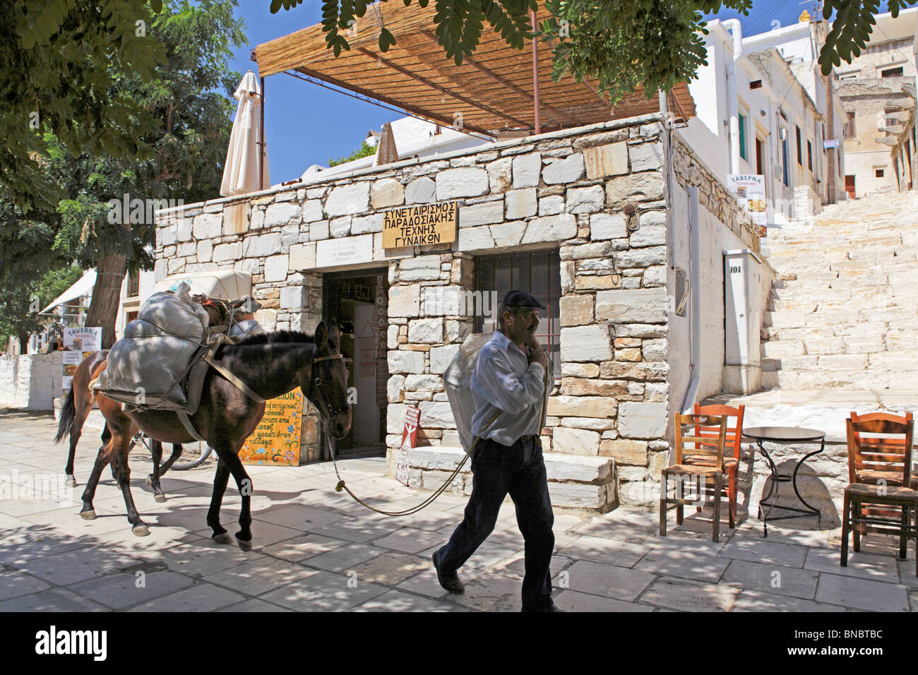 native man with a mule at the mountain village Apeiranthos, Island of ...