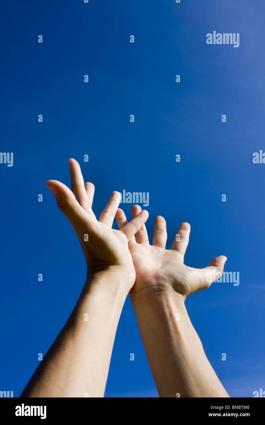 Hand on sky,looking for help Stock Photo - Alamy