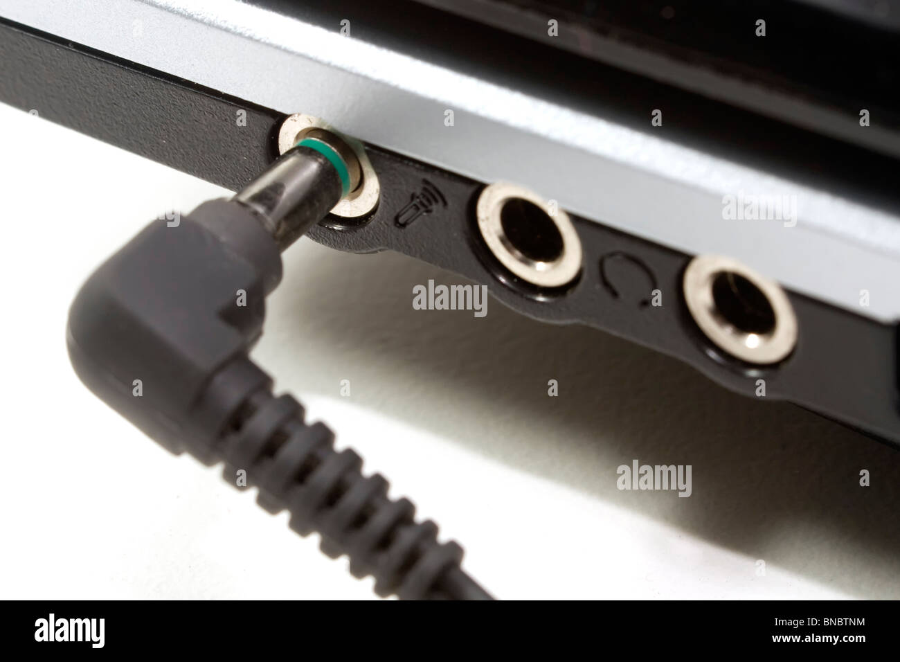 Plug into the audio input of the notebook Stock Photo - Alamy