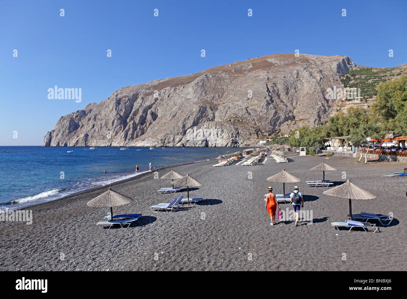 the black sandy beach of Kamari, Santorini Island, Cyclades, Aegean ...