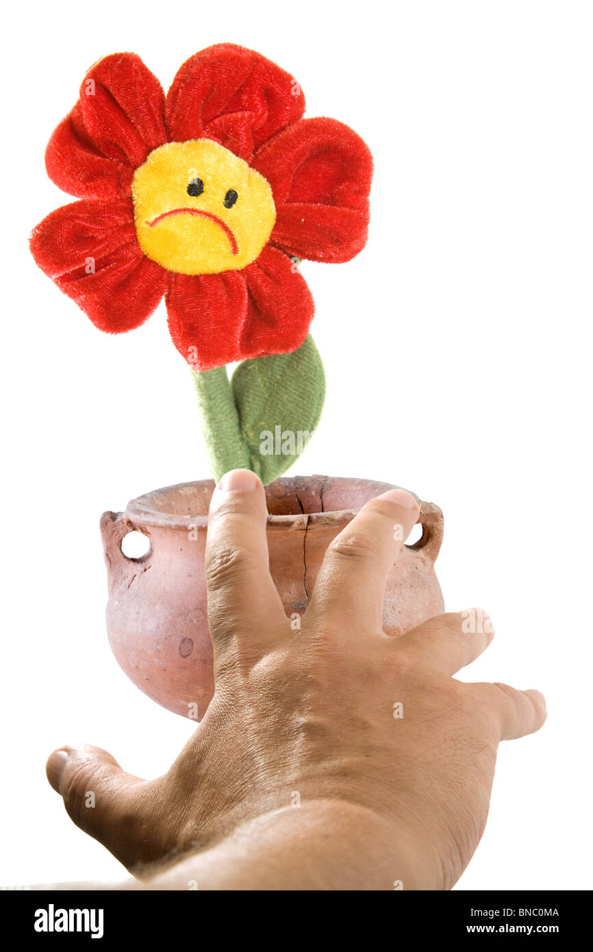 Destructive hand going to the sad flower Stock Photo - Alamy