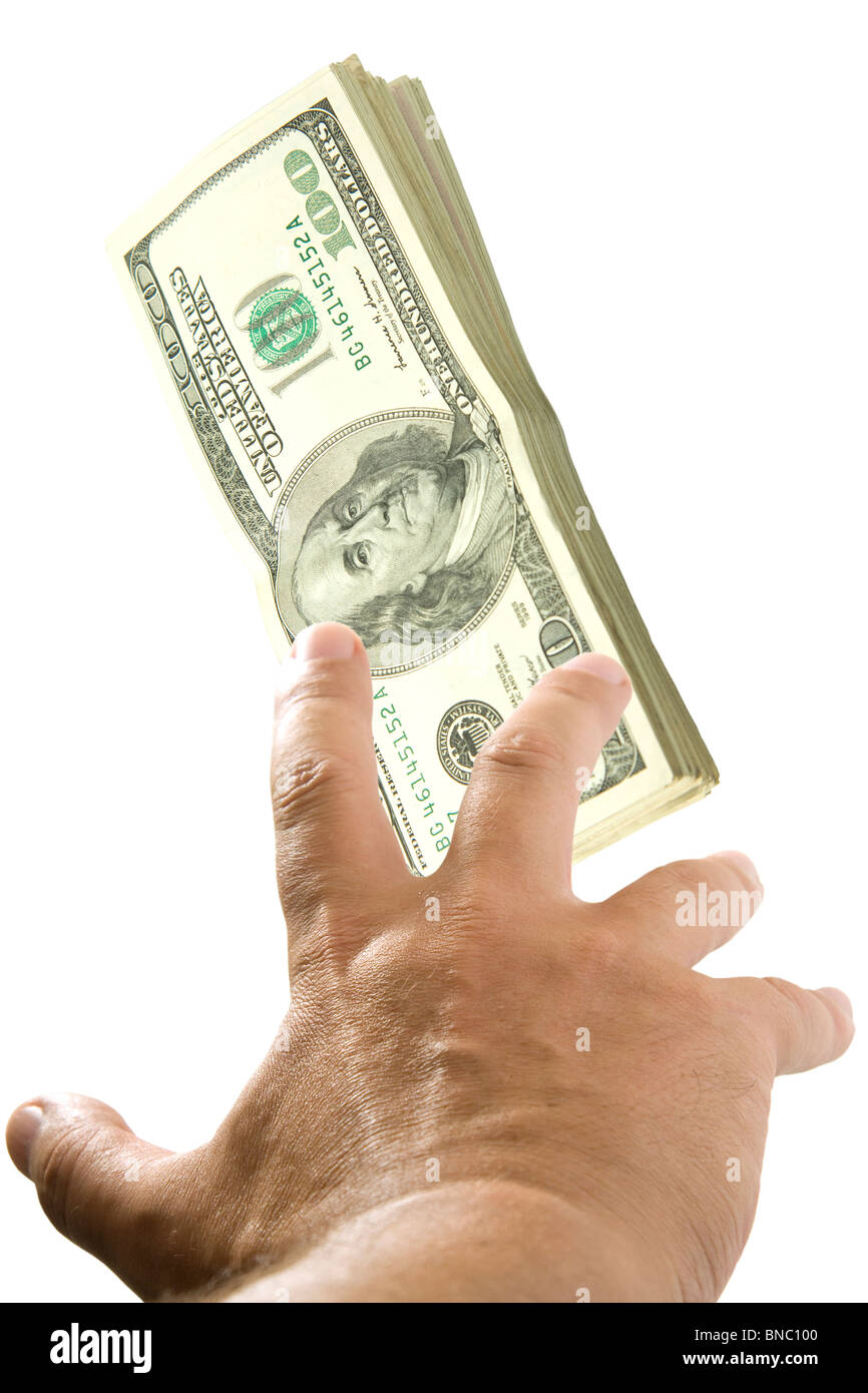 Hand trying to take a stack of dollars (vertical photo Stock Photo - Alamy