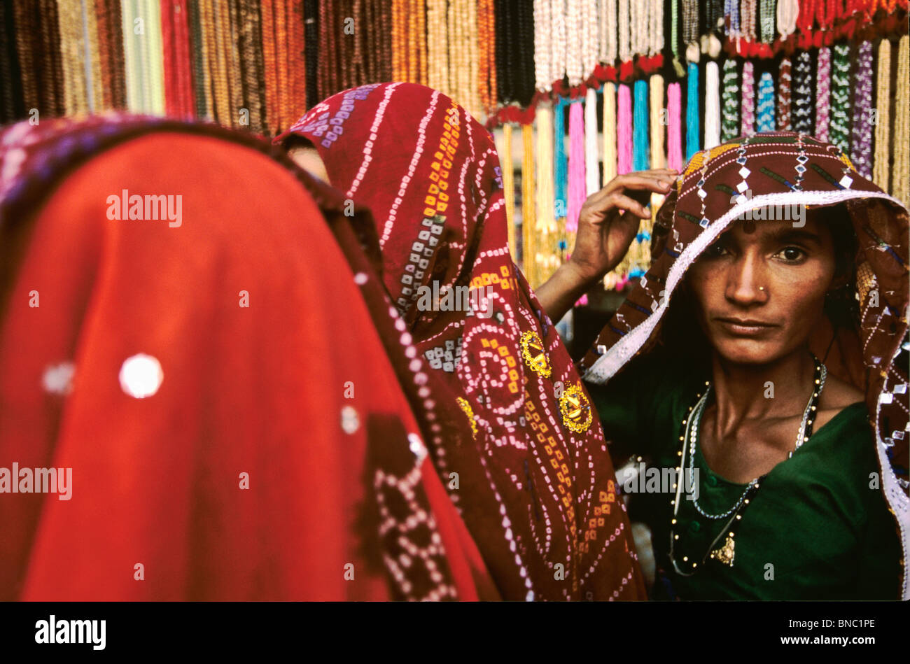 Sari clad women at Pushkar's old bazaar during the annual Camel Fair ...