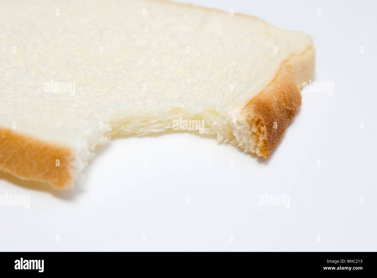 slice of bread with bite taken out Stock Photo - Alamy