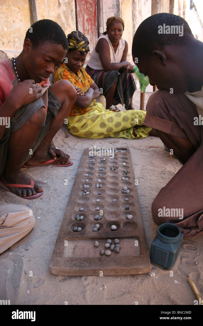Mozambicans playing traditional board game in the street, Ilha de ...