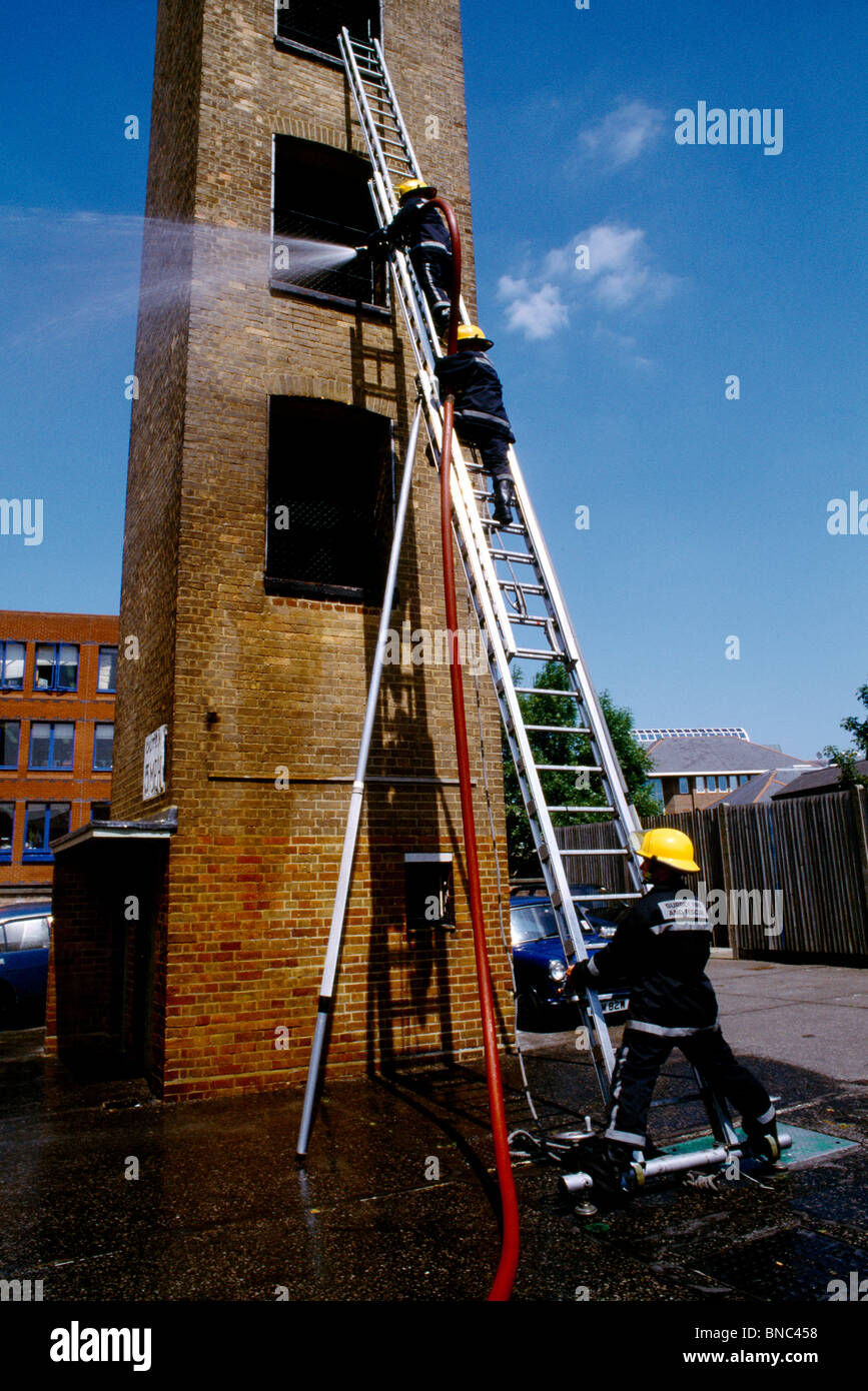 Firemen Climbing A Ladder Up The Training Tower Stock Photo - Alamy