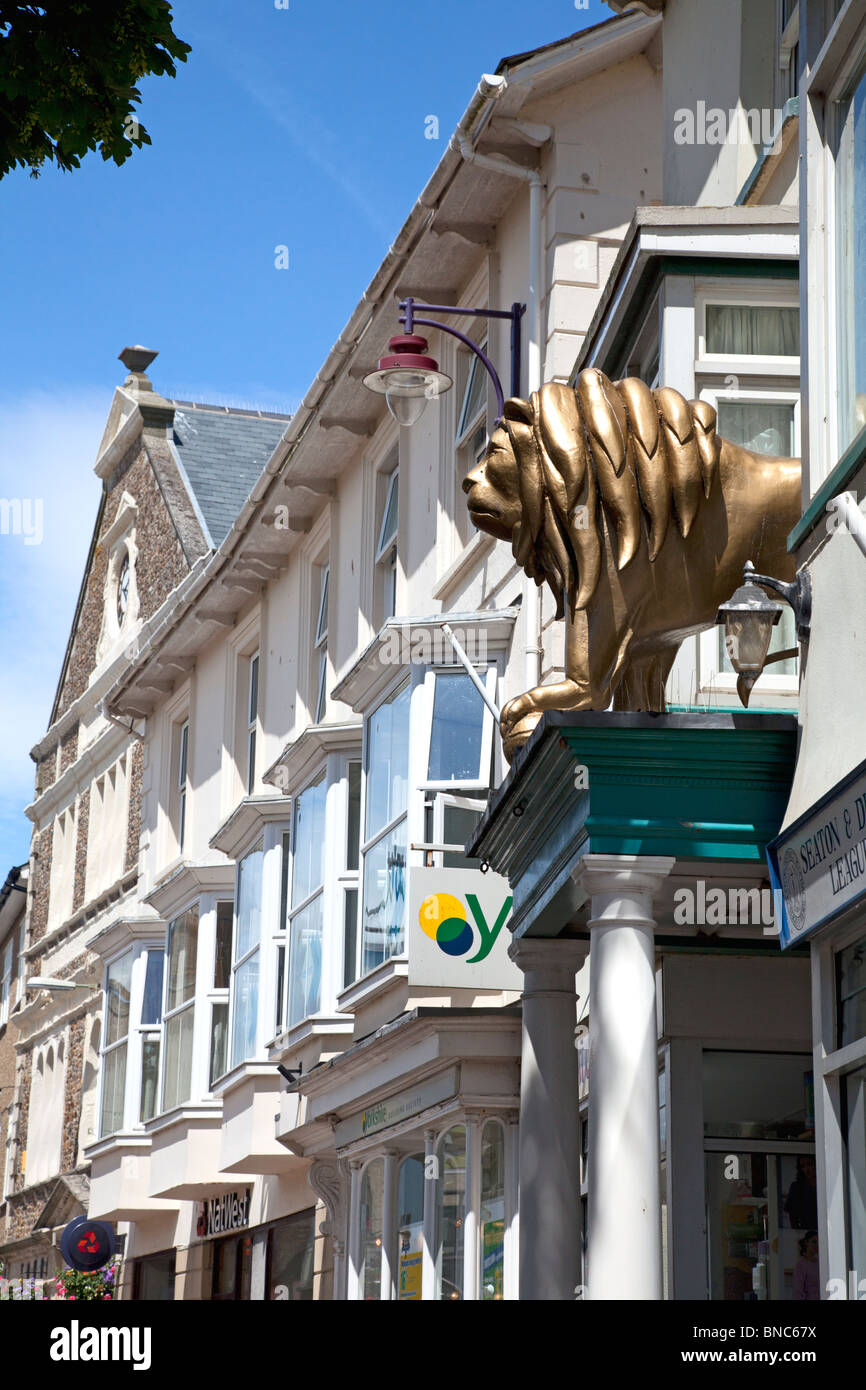 Golden lion above shop front, Seaton, Devon Stock Photo - Alamy