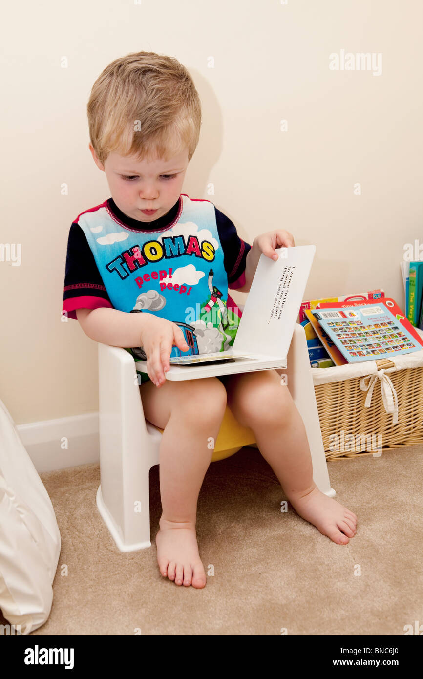 Young boy on reading on his potty Stock Photo - Alamy