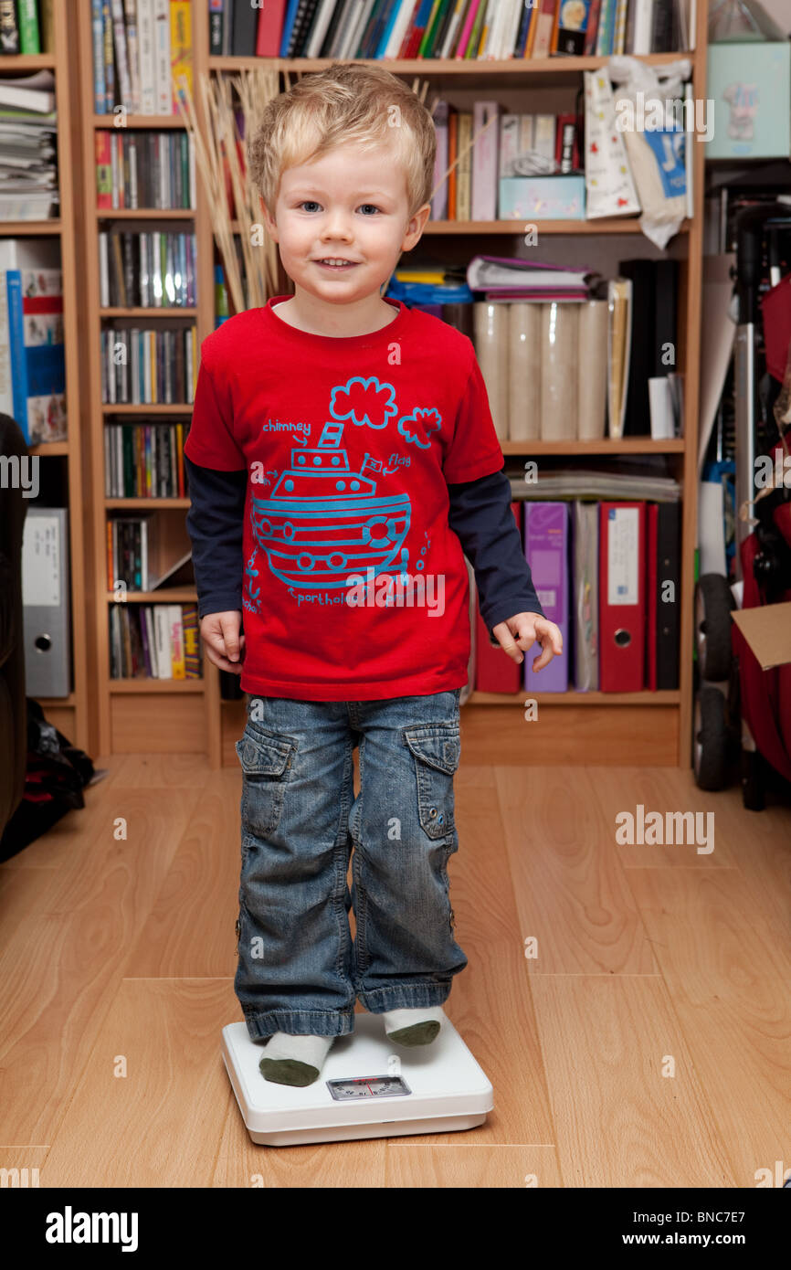 A young boy stood on bathroom scales Stock Photo - Alamy