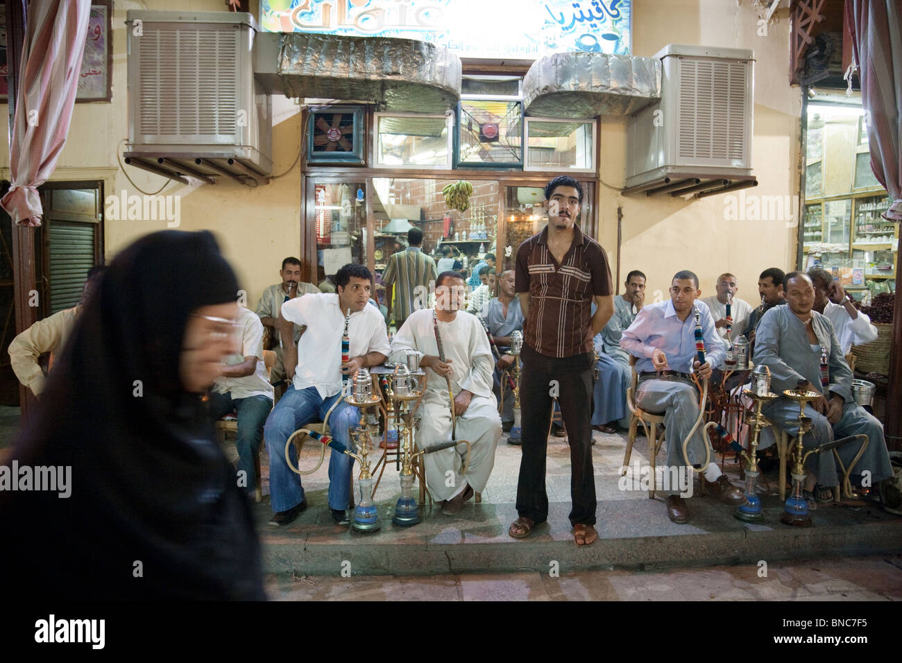 Local Egyptian Men Smoking Shisha Pipes In A Bar In The Evening The