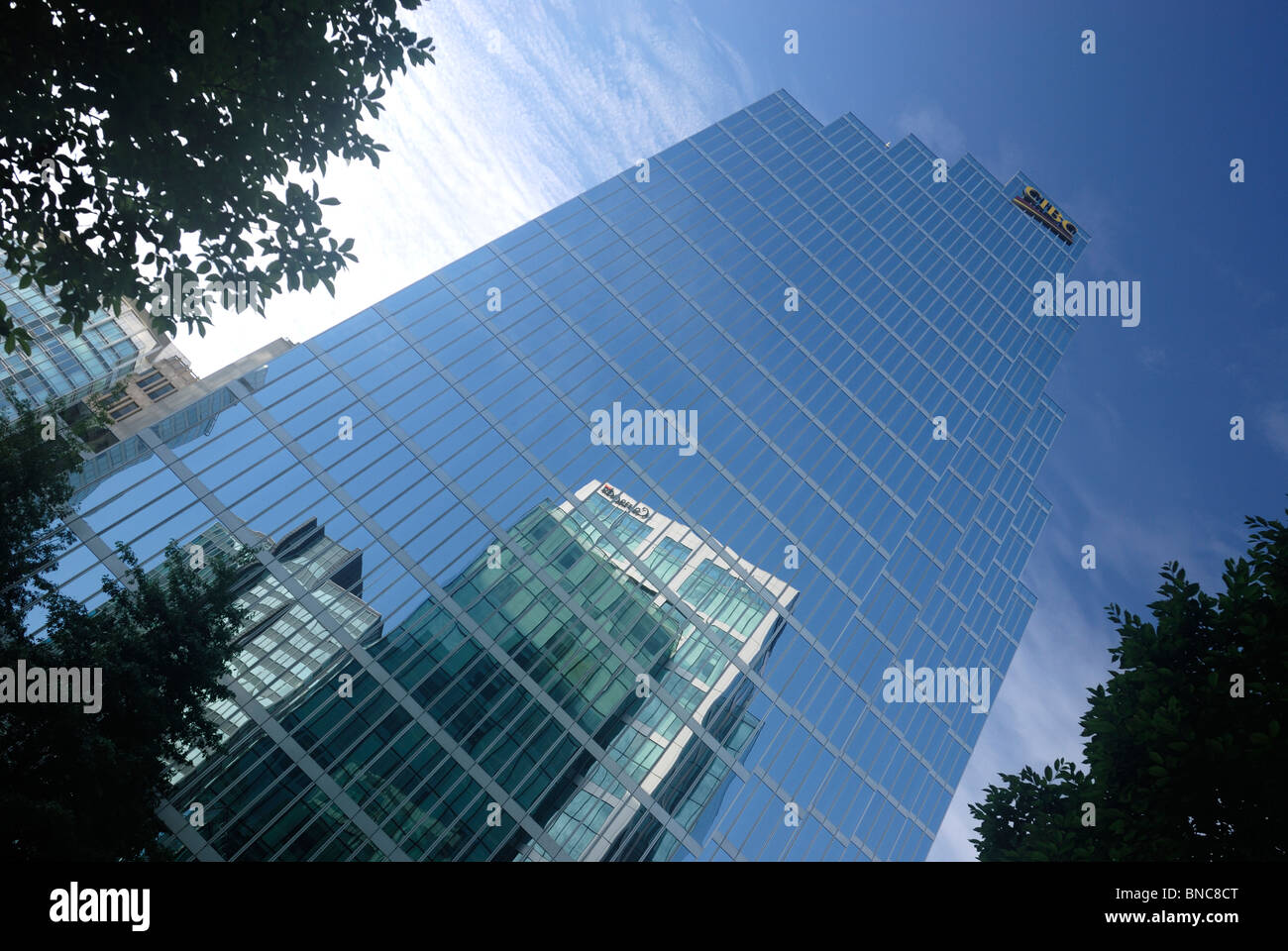 CIBC glass tower reflecting surrounding buildings in the downtown City ...