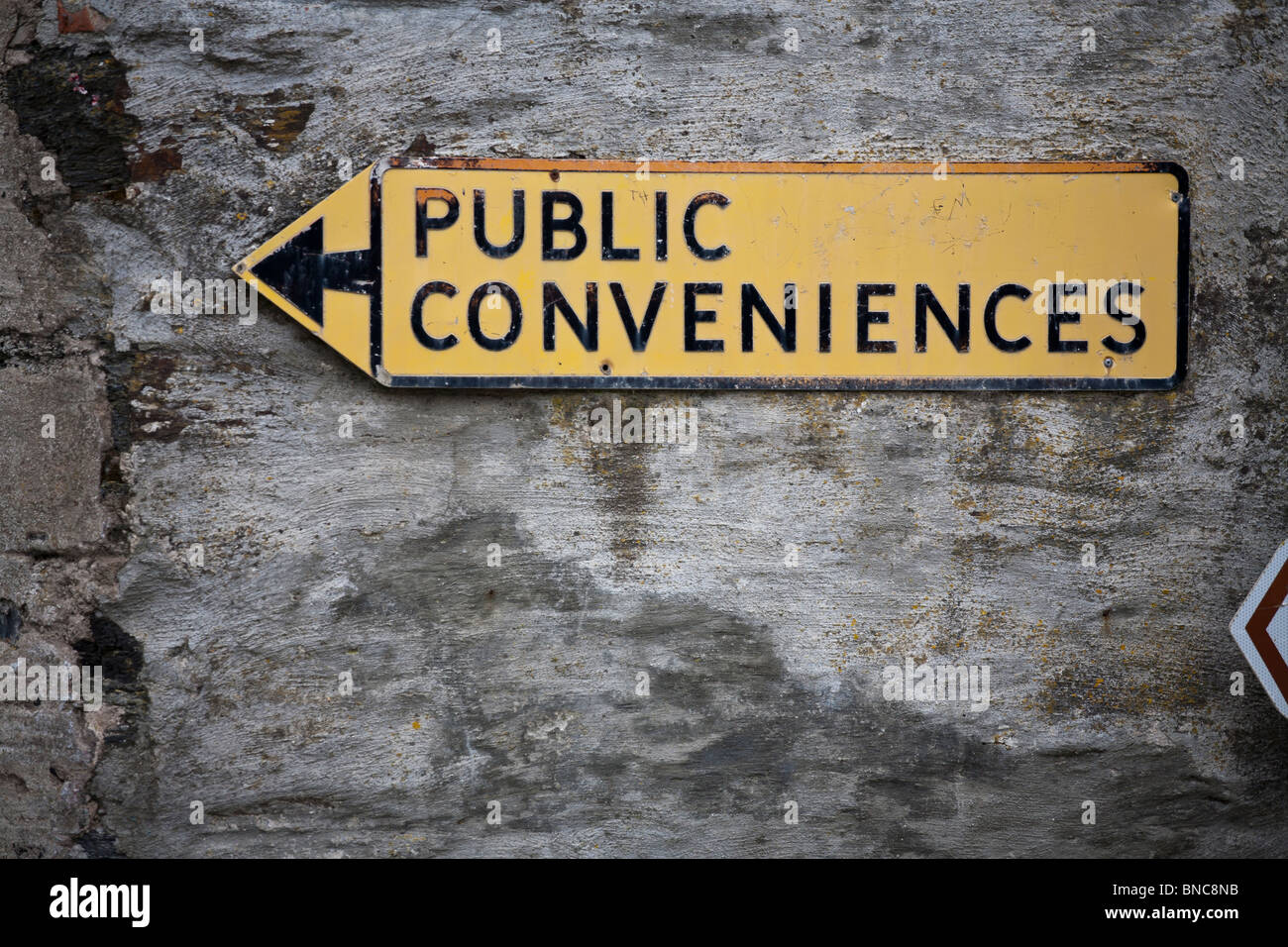 Public Conveniences Directional Sign. A yellow road sign directing ...