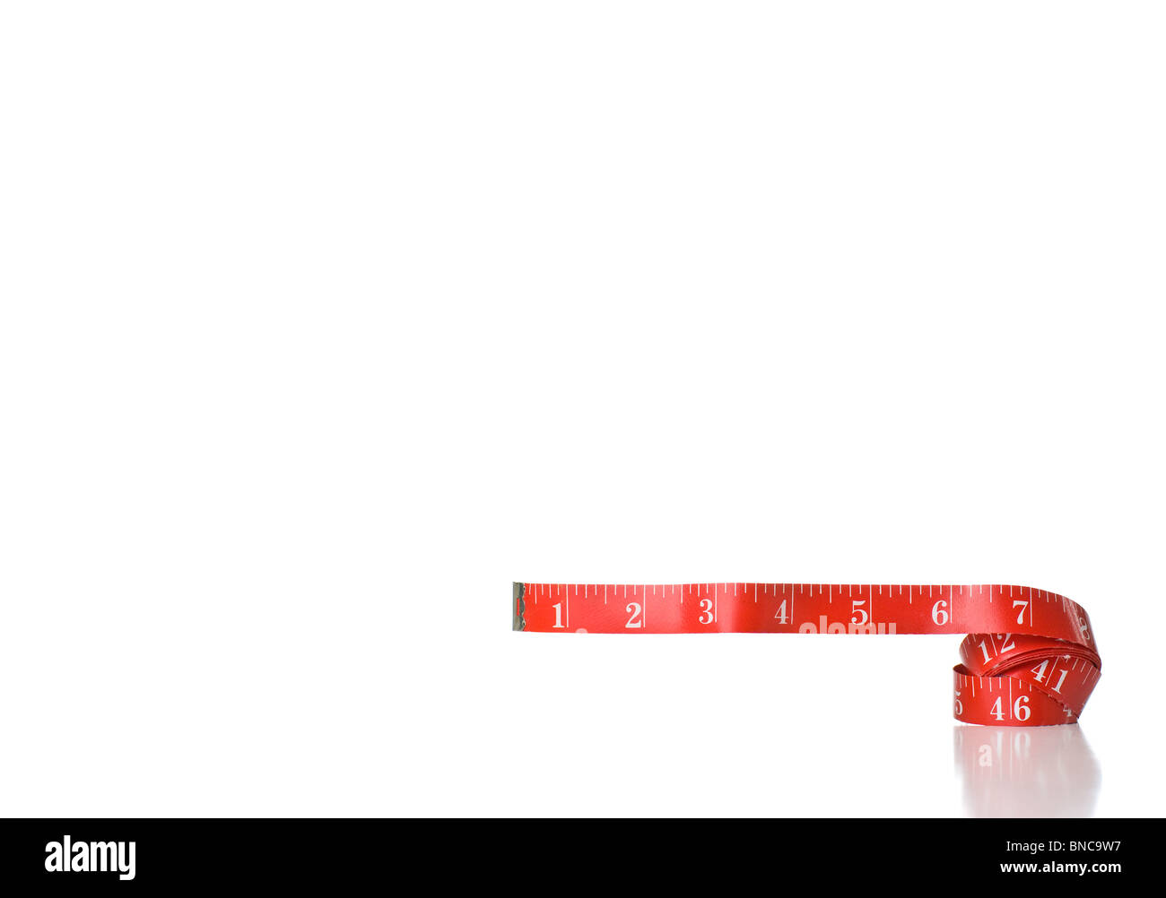 A coiled red measuring tape Stock Photo - Alamy