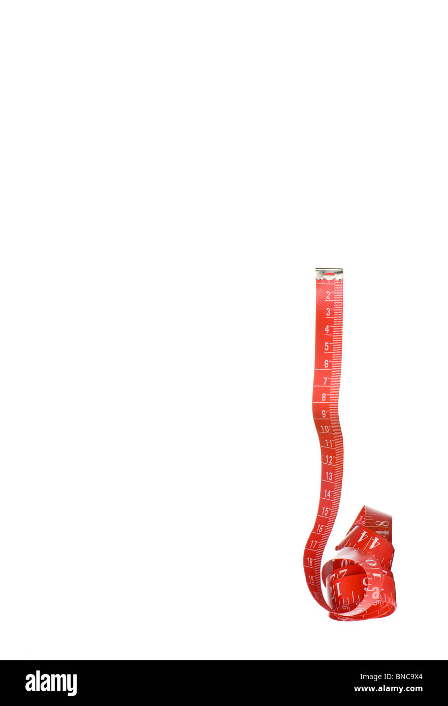 A coiled red measuring tape showing both inches and centimeters Stock ...