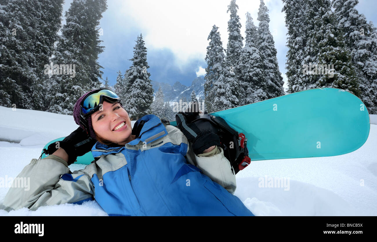 Pretty girl with snowboard smiling Stock Photo - Alamy