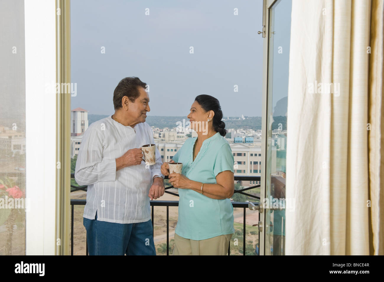 Couple drinking tea in balcony hi-res stock photography and images - Alamy