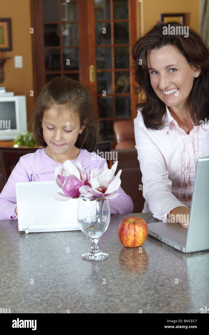 daughter working on laptops on a home background Stock Photo - Alamy