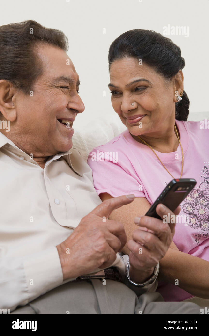Couple text messaging on a mobile phone Stock Photo - Alamy