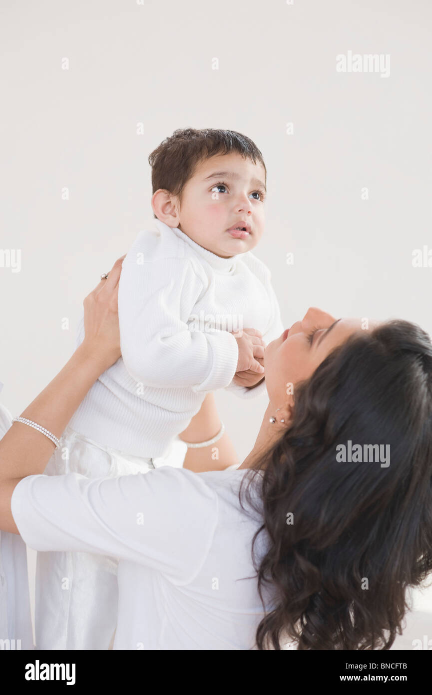 Woman lifting her son Stock Photo - Alamy