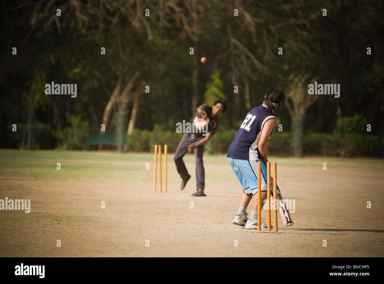 Two boys playing cricket in a playground, New Delhi, India Stock Photo ...