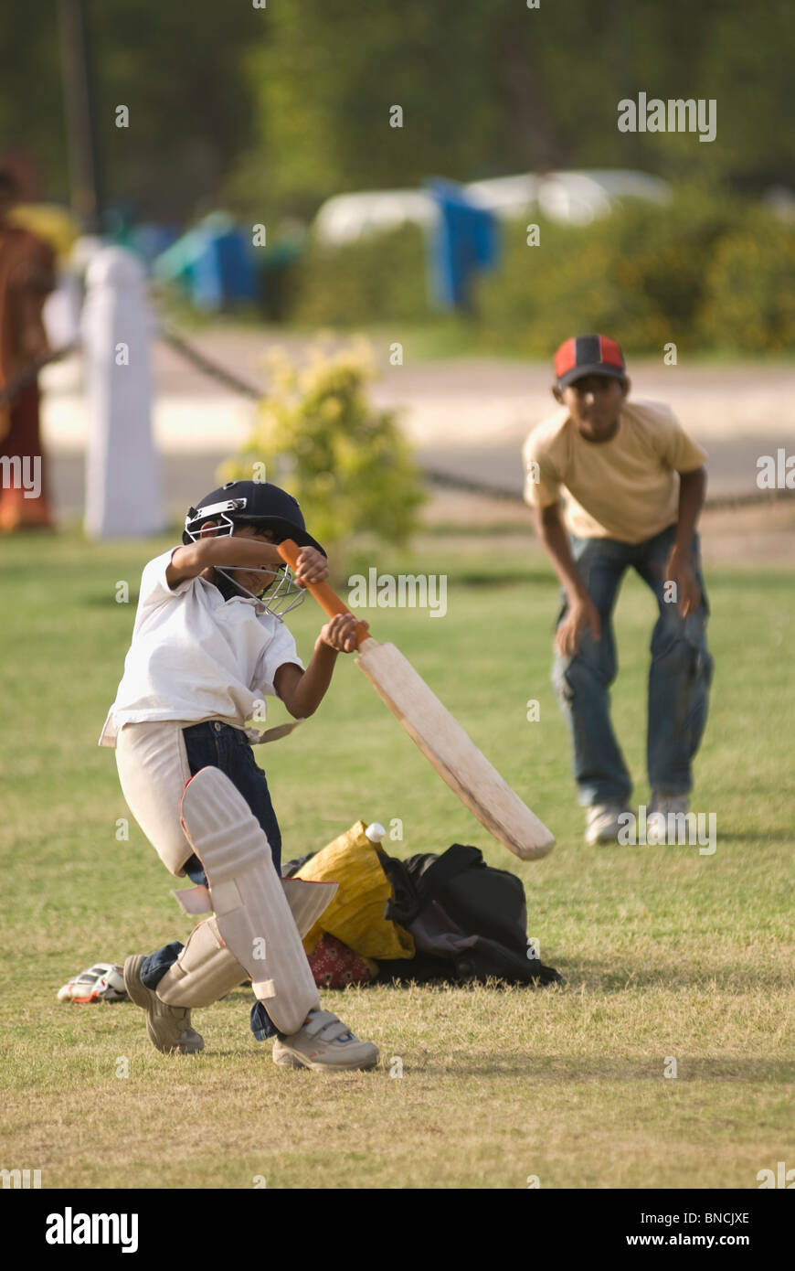 Boys playing cricket in a playground, New Delhi, India Stock Photo - Alamy