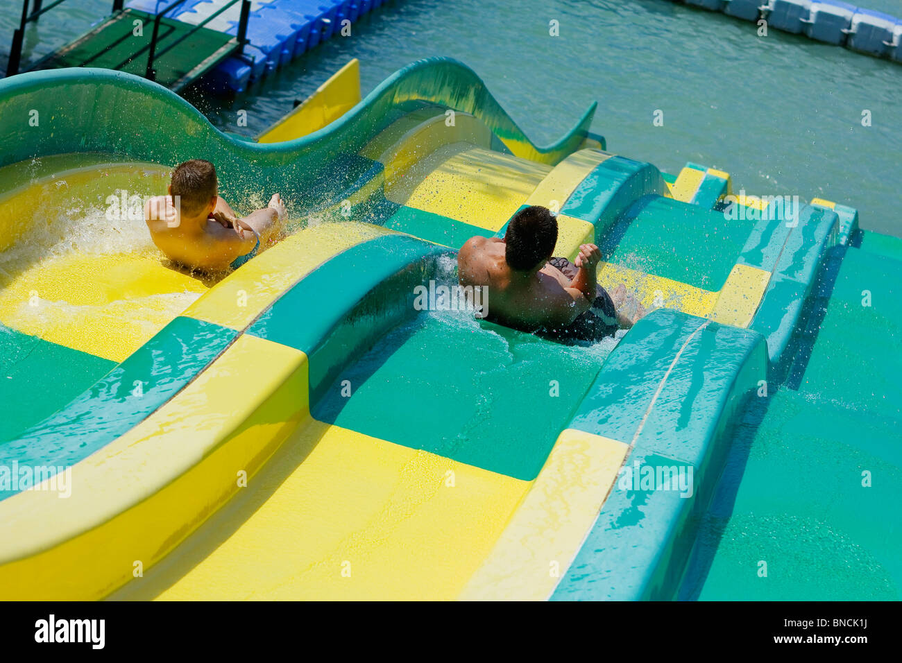 Two people sliding down in the waterslip at the beach of lake Balaton ...