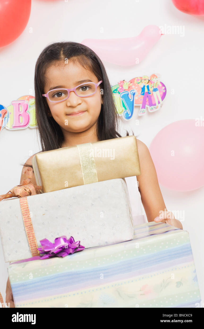 Portrait of a girl holding birthday presents Stock Photo - Alamy